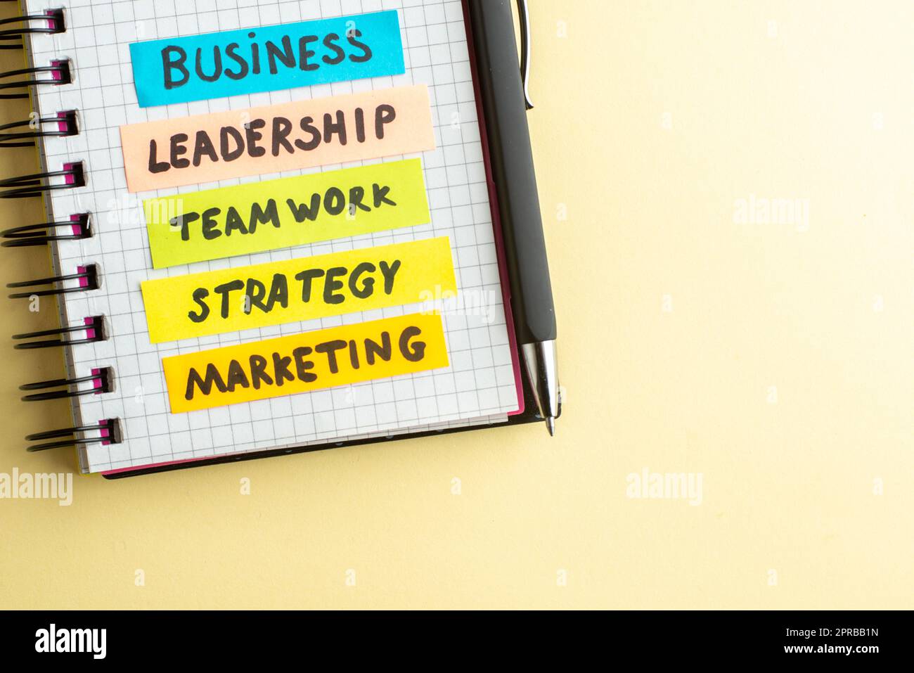 top view different business terms on little stickers in notepad light ...