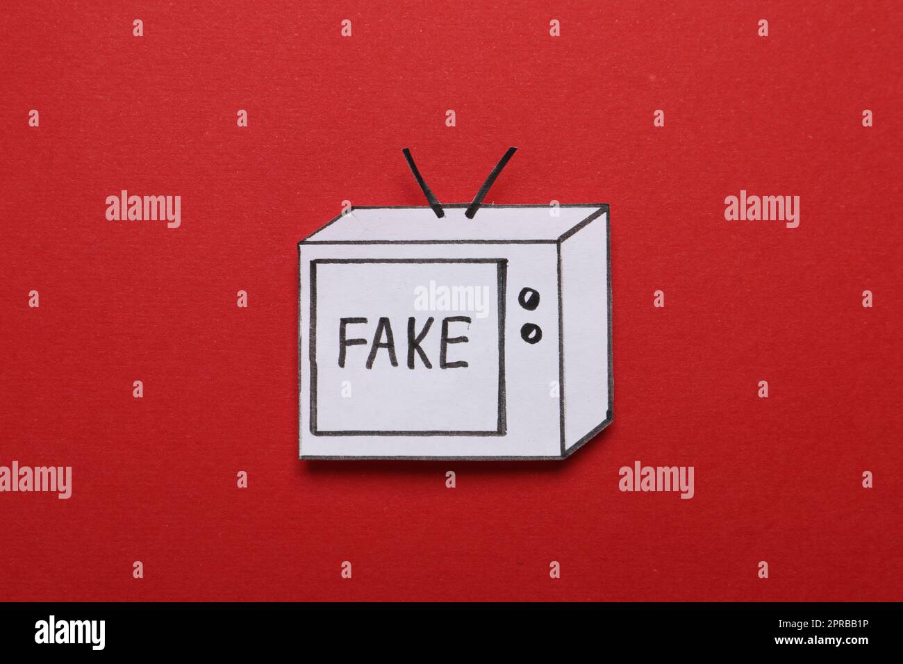 Paper TV with word Fake on red background, top view. Information ...