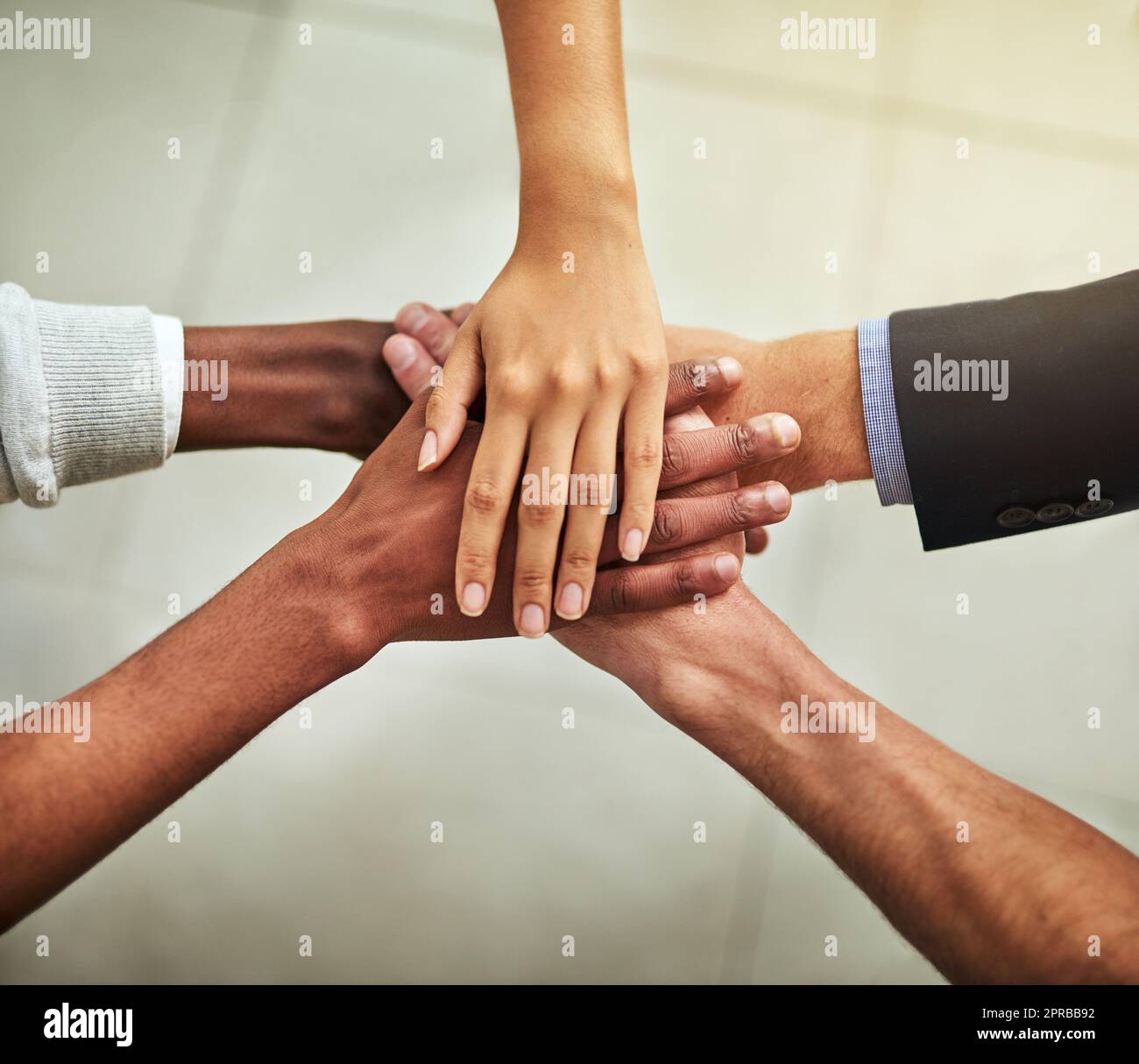 Hands of business people stacked together in group for unity, teamwork ...