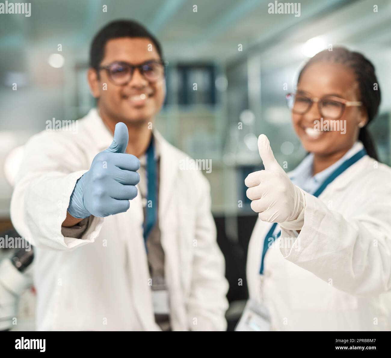 Our experiment was a great success. two scientists showing thumbs up in ...