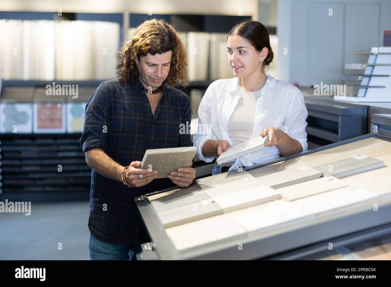 Nice couple in hardware store looking to buy bathroom tiles Stock Photo ...