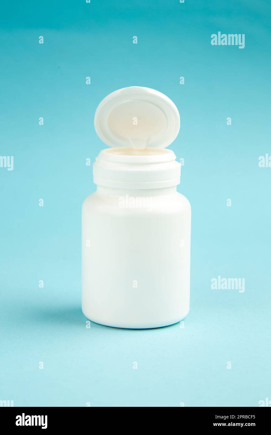 front view little pills can on blue background color virus drug ...