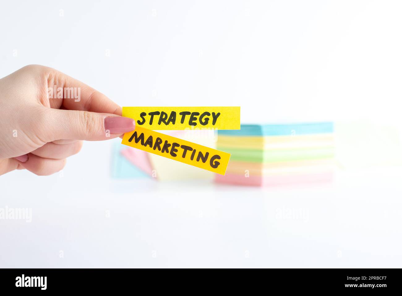 front view strategy marketing little stickers in female hands on white ...