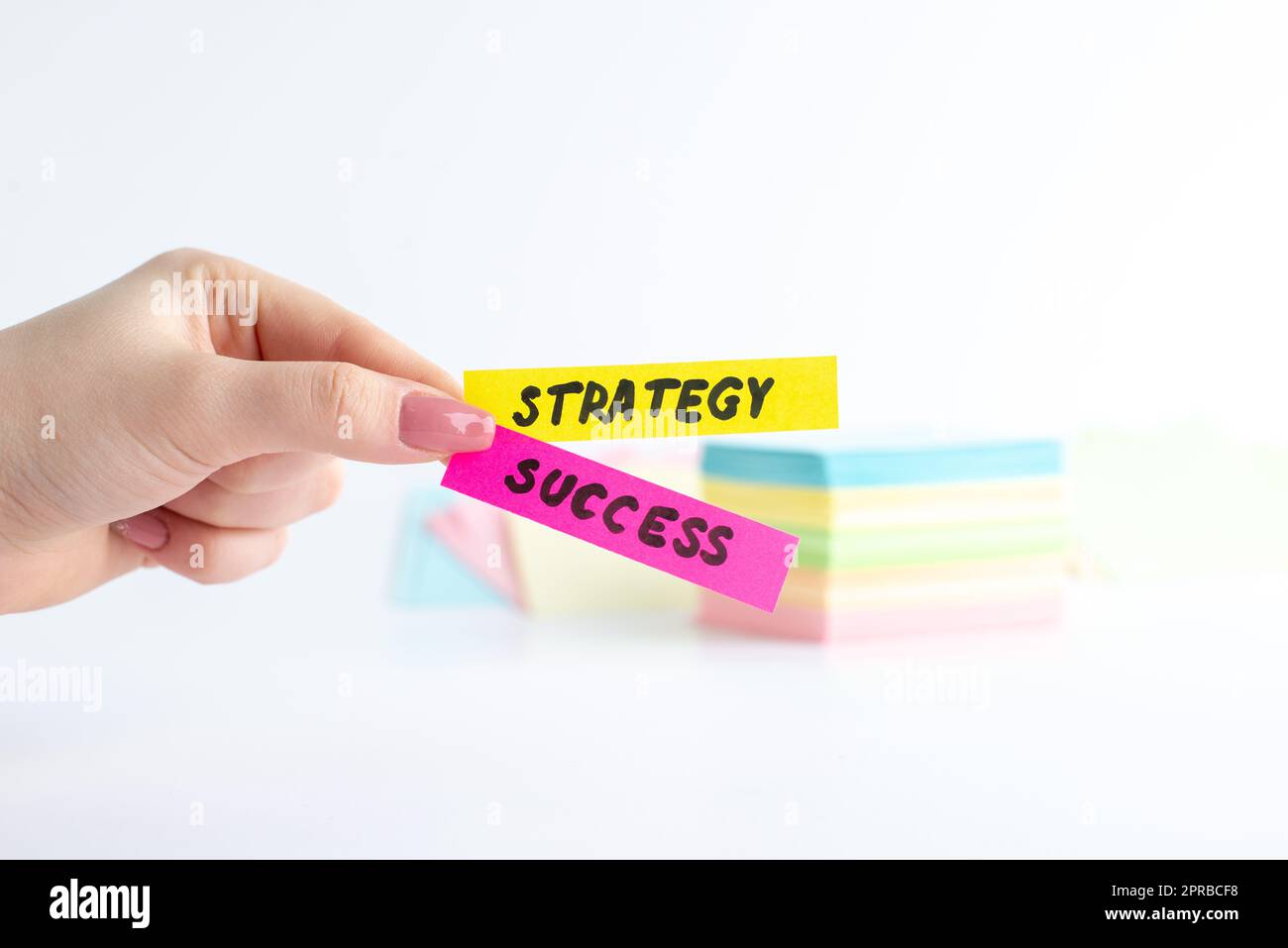 front view strategy success little stickers in female hands on white ...