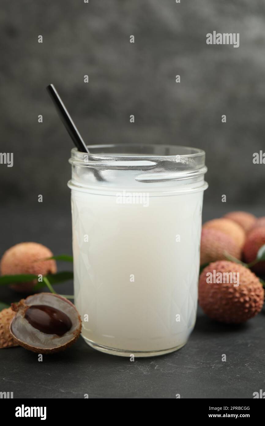 Fresh lychee juice and fruits on grey table Stock Photo - Alamy