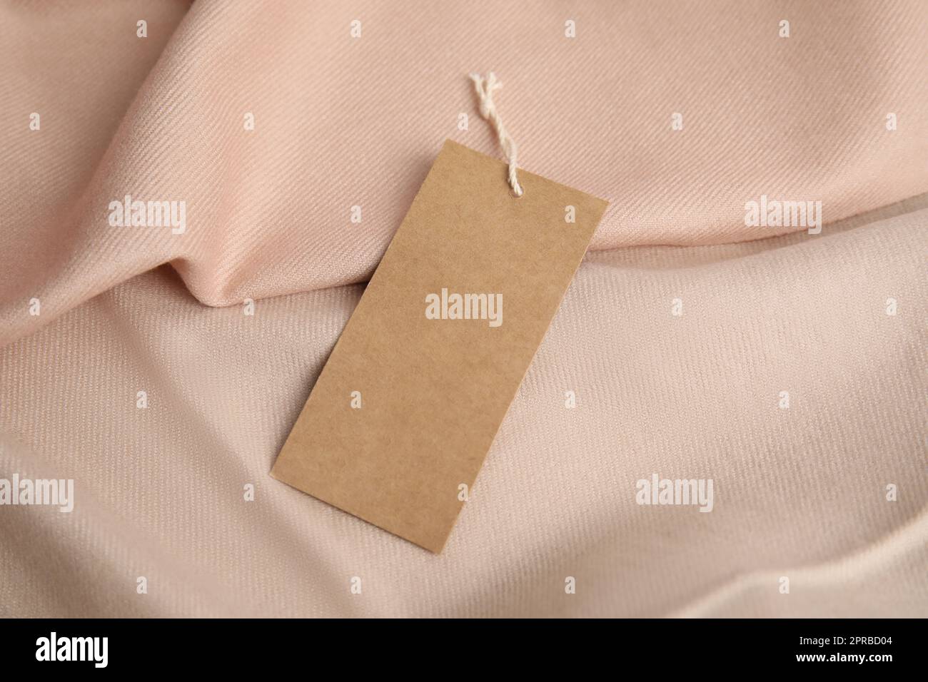 Warm beige cashmere garment with tag, closeup Stock Photo - Alamy