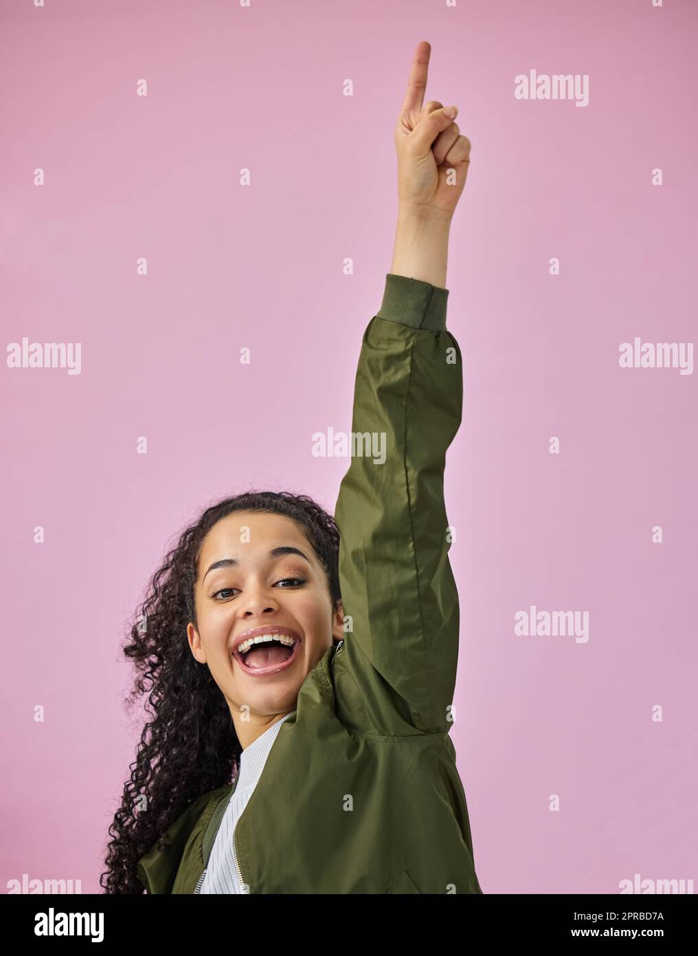 To the moon. an attractive young woman standing alone against a pink ...