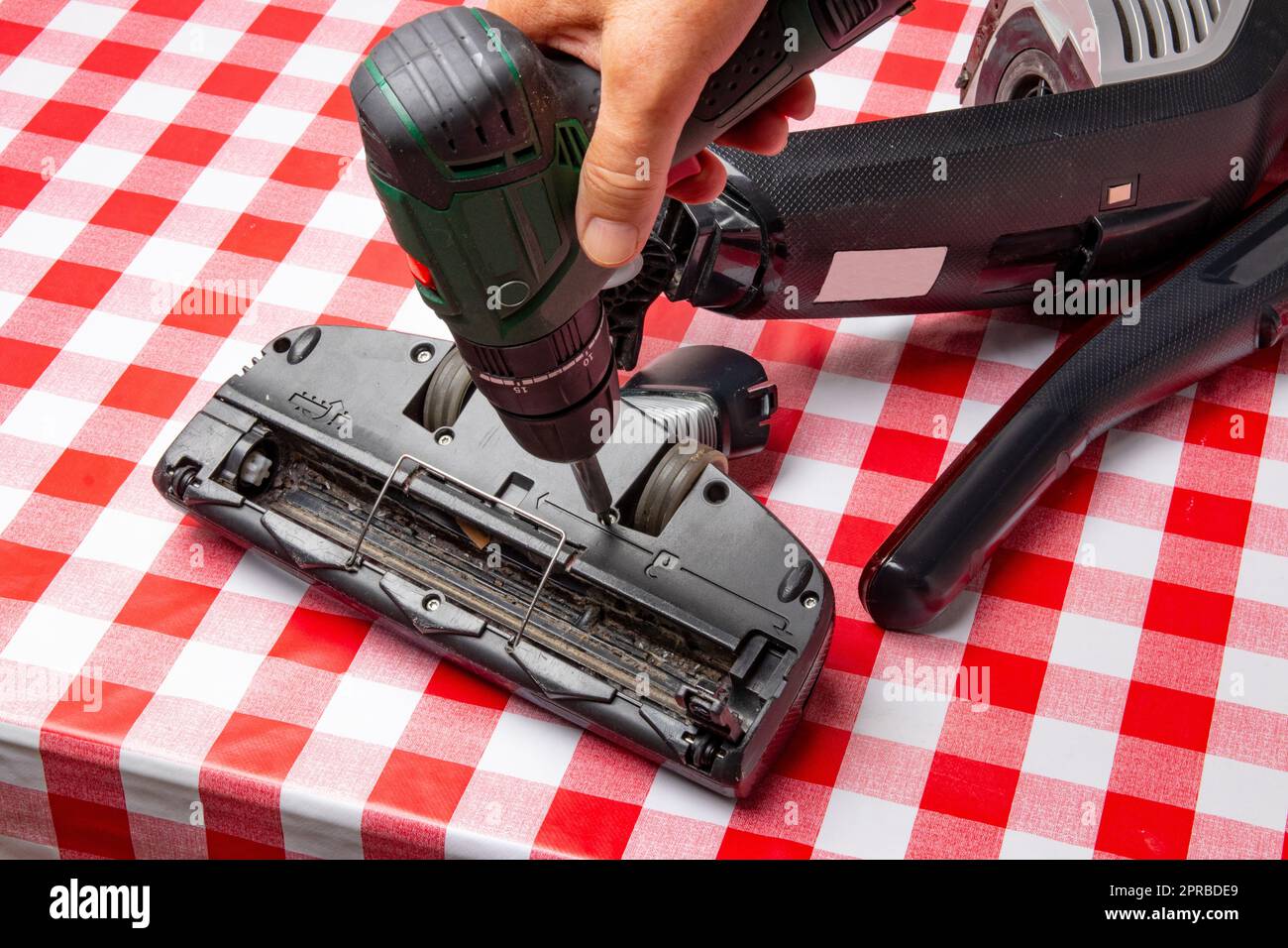 Repair of household appliances. Professional technician repairs a ...