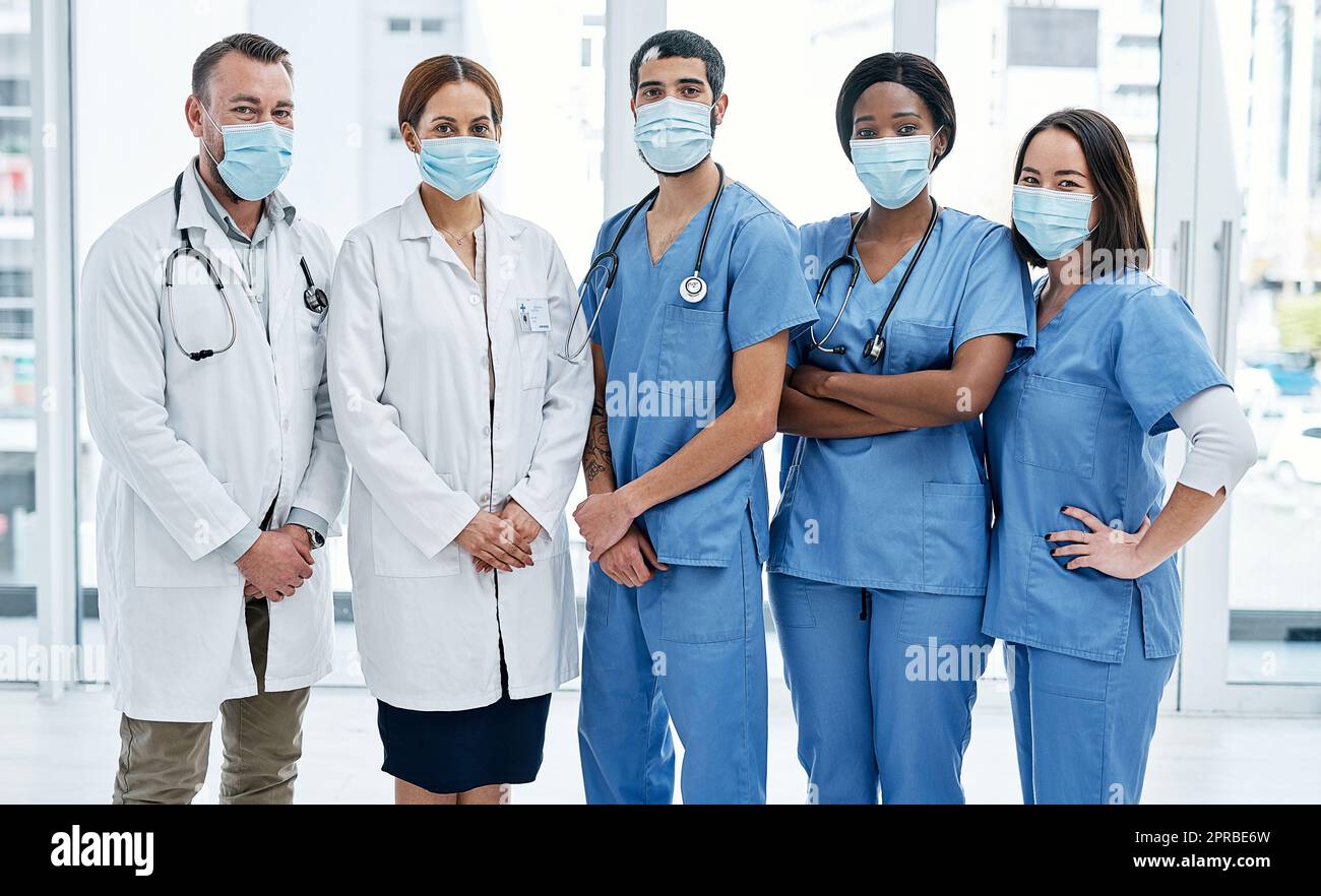 Dedicated specialists standing ready to help. Portrait of a group of medical practitioners ...