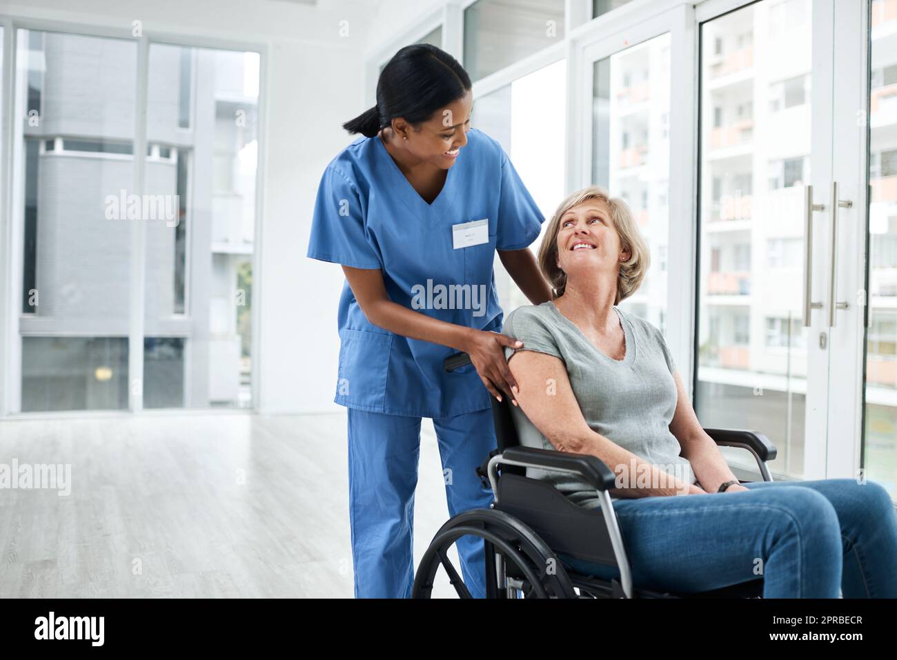 Work is where the heart is. a young nurse caring for a senior woman in ...