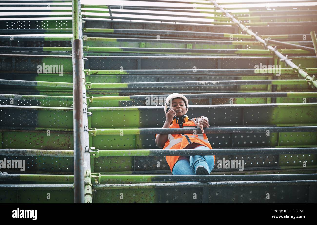 Giving commands while conducting inspections. a young woman using a ...
