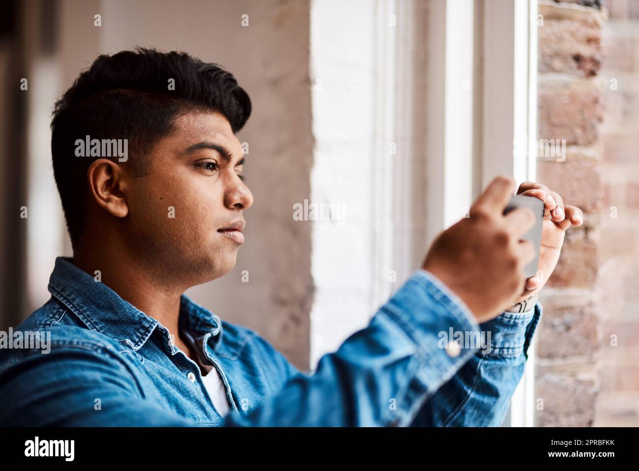 The view from up here is really great. a young businessman taking a ...