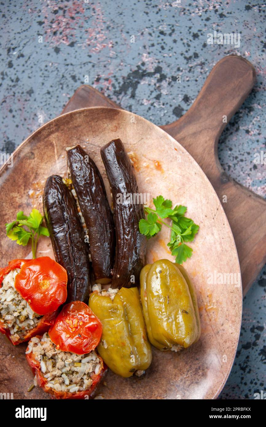 top view eggplant dolma with cooked tomatoes and bell-peppers filled ...