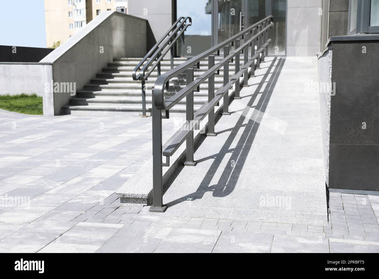 Outdoor stairs with ramp and metal railing Stock Photo - Alamy
