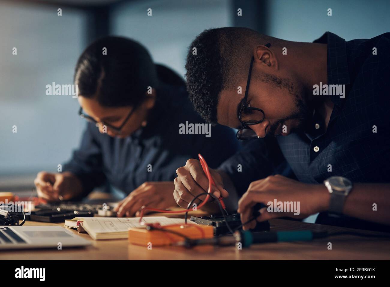 Getting things fixed before the break of dawn. two young technicians ...