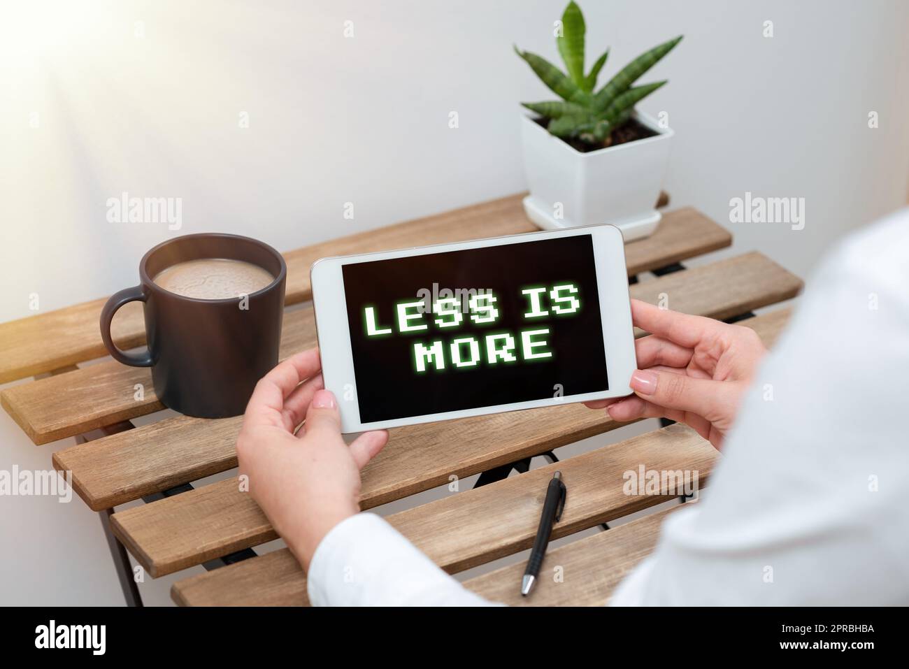 Hand writing sign Less Is More. Concept meaning Minimalist approach to ...