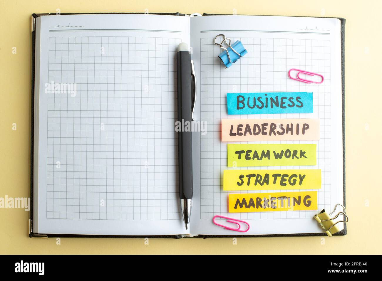 top view different business terms on little stickers in notepad light ...