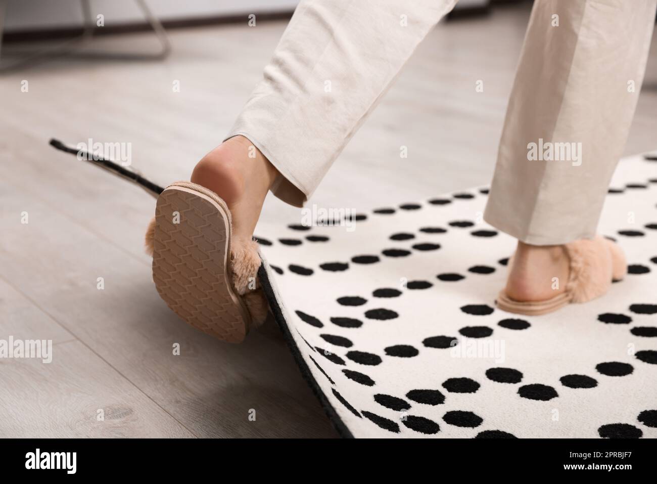 Woman tripping over carpet at home, closeup Stock Photo - Alamy