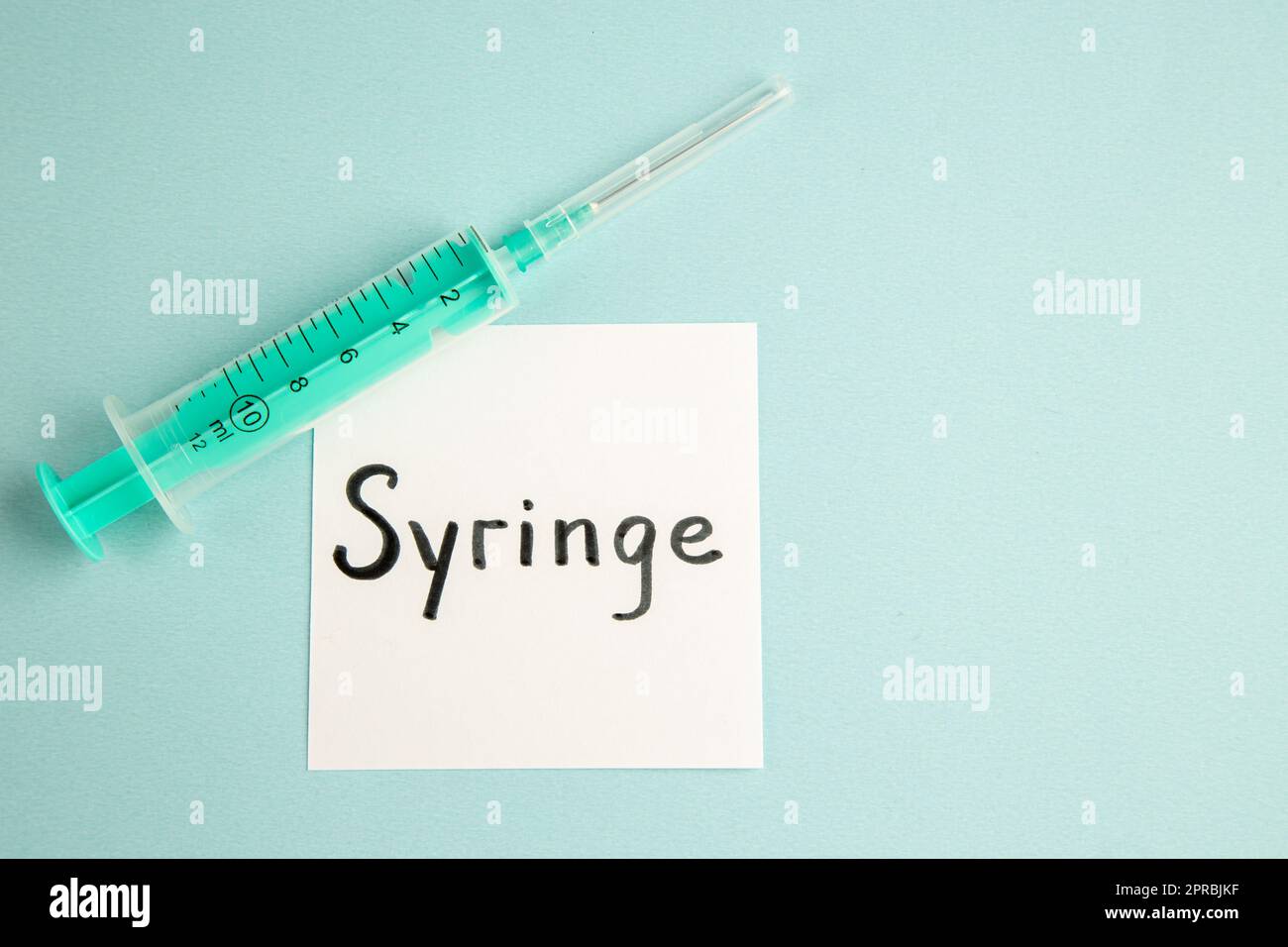 top view green injection with syringe written note on blue background ...