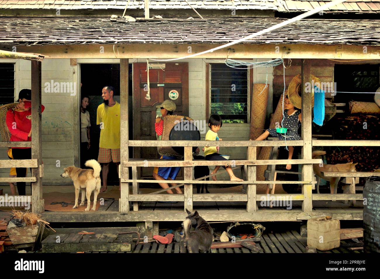 People are photographed as they are standing at the veranda of the ...
