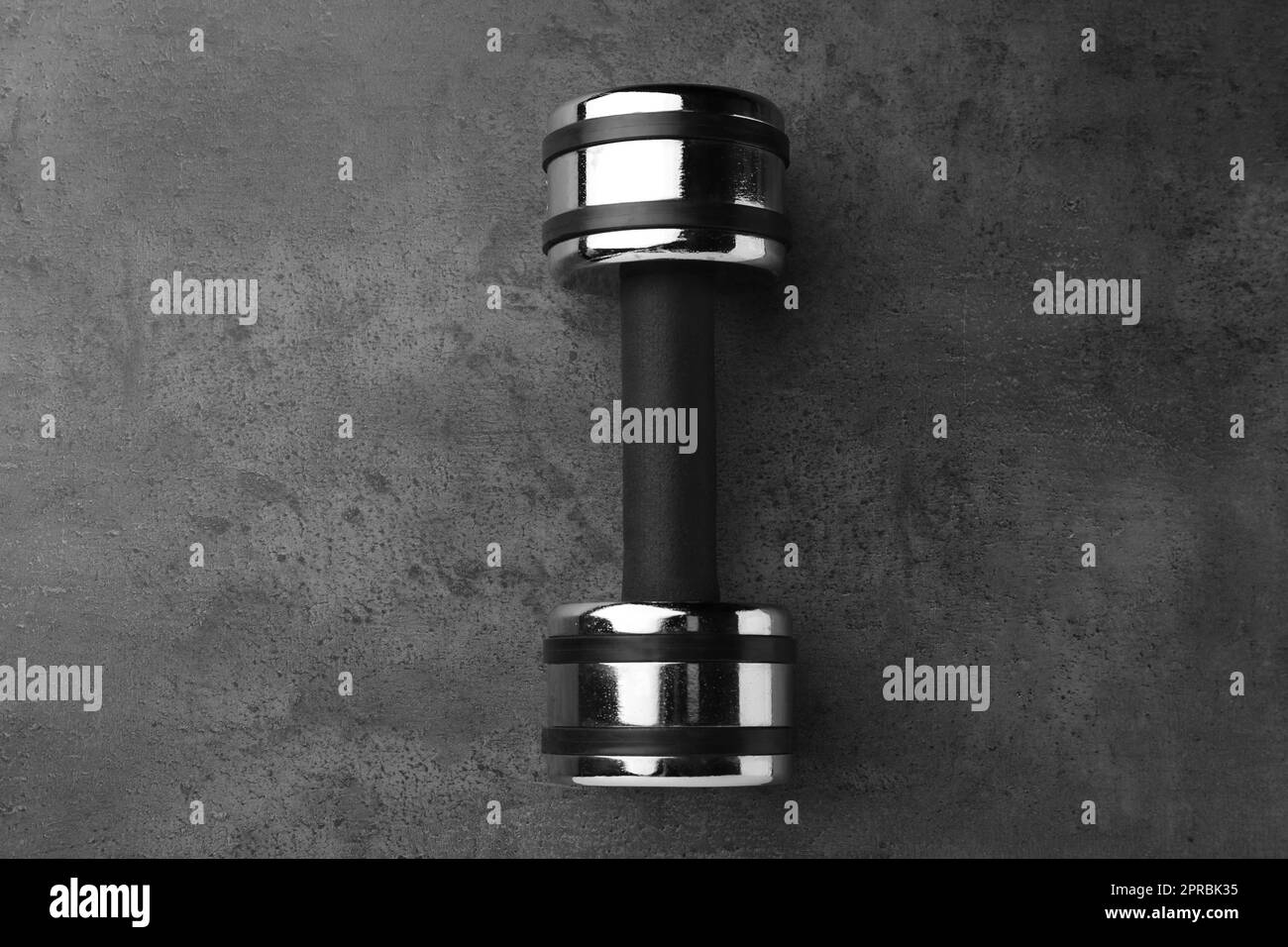 One dumbbell on grey table, top view Stock Photo - Alamy