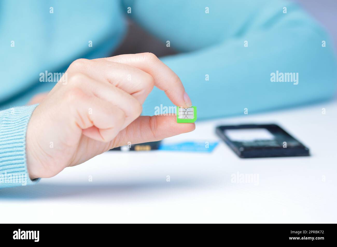 Woman hand holding a micro sim card Stock Photo - Alamy