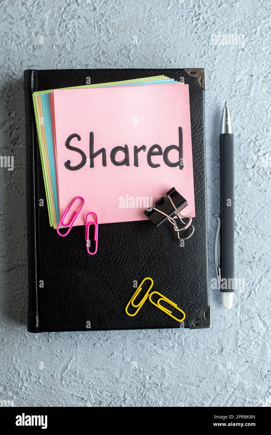 top view shared written note with stickers notepad and pen on white ...