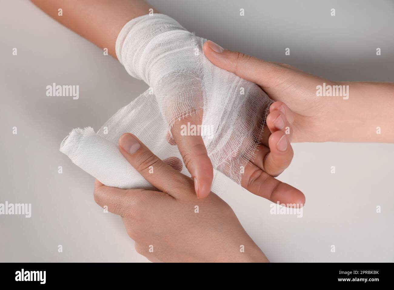 Doctor bandaging patients wrist hi-res stock photography and images - Alamy