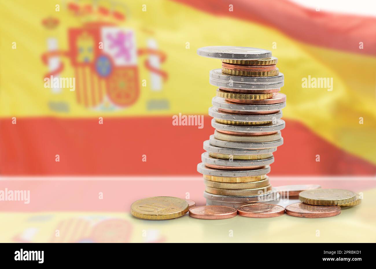 Coins stacked on each other in different positions with Spanish flag ...