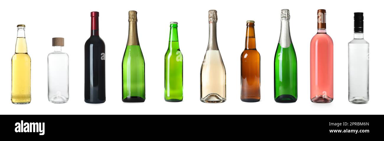 Set with bottles of different alcohol drinks on white background ...