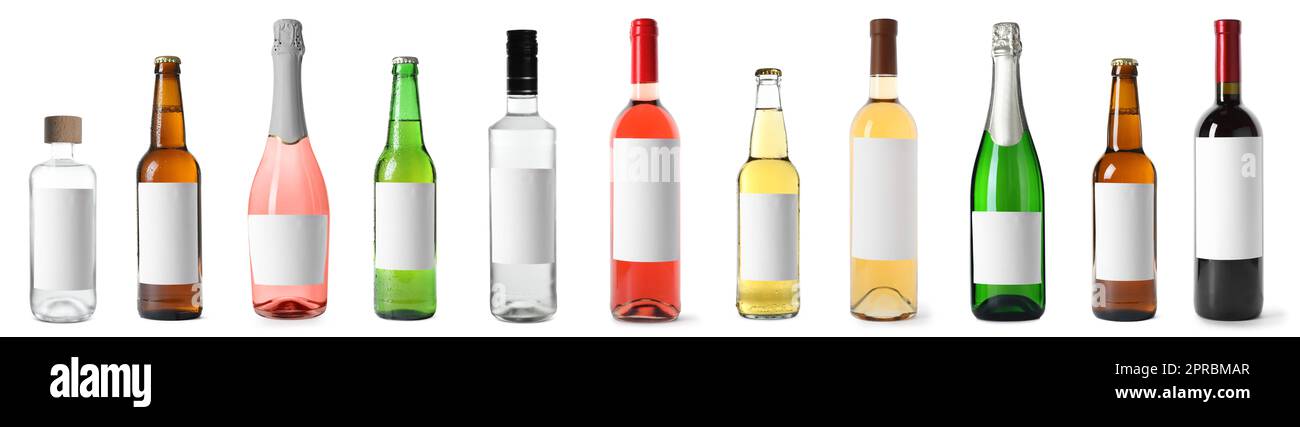 Set with bottles of different alcohol drinks on white background ...