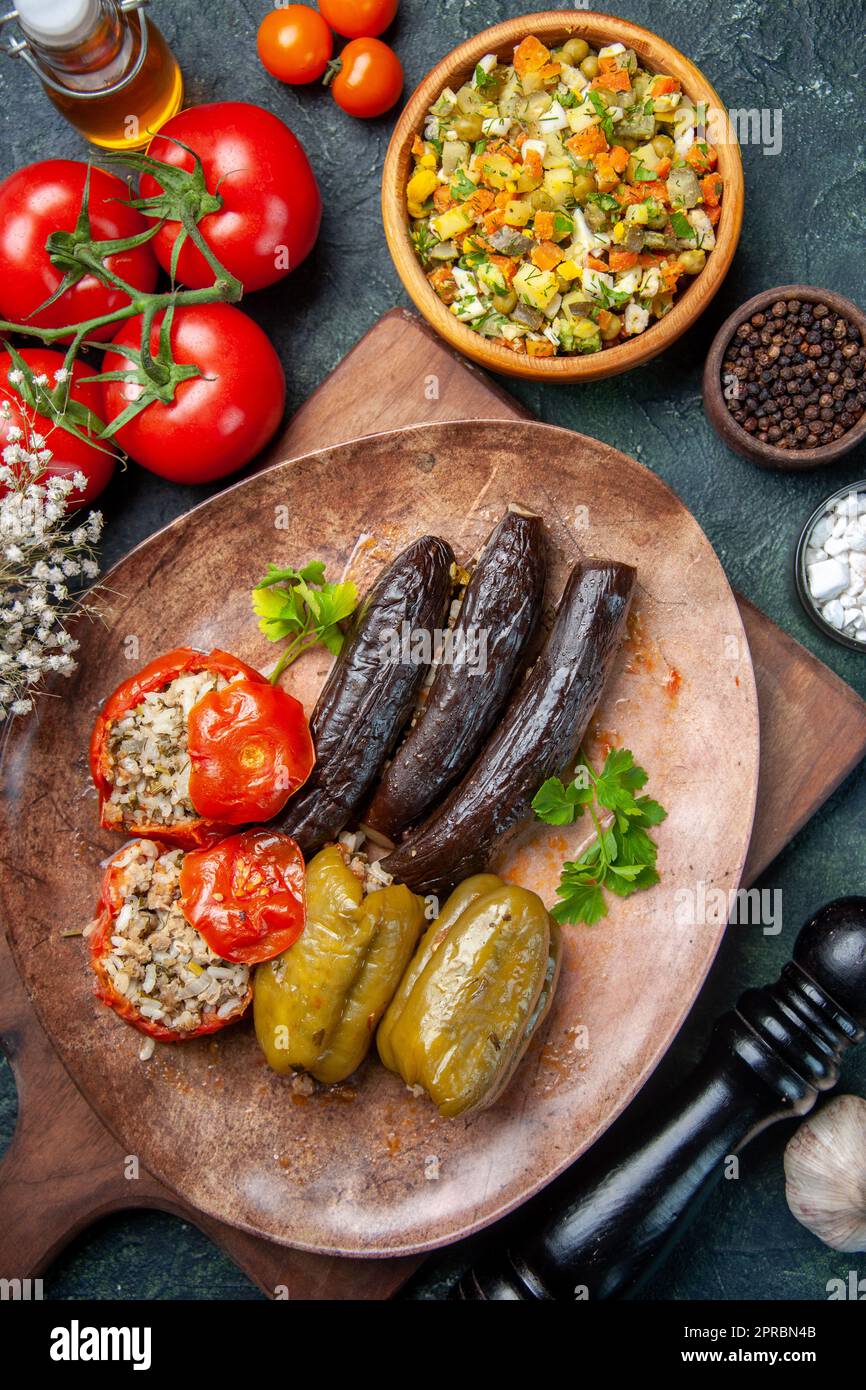 top view tasty vegetable dolma with red tomatoes on a dark-blue ...