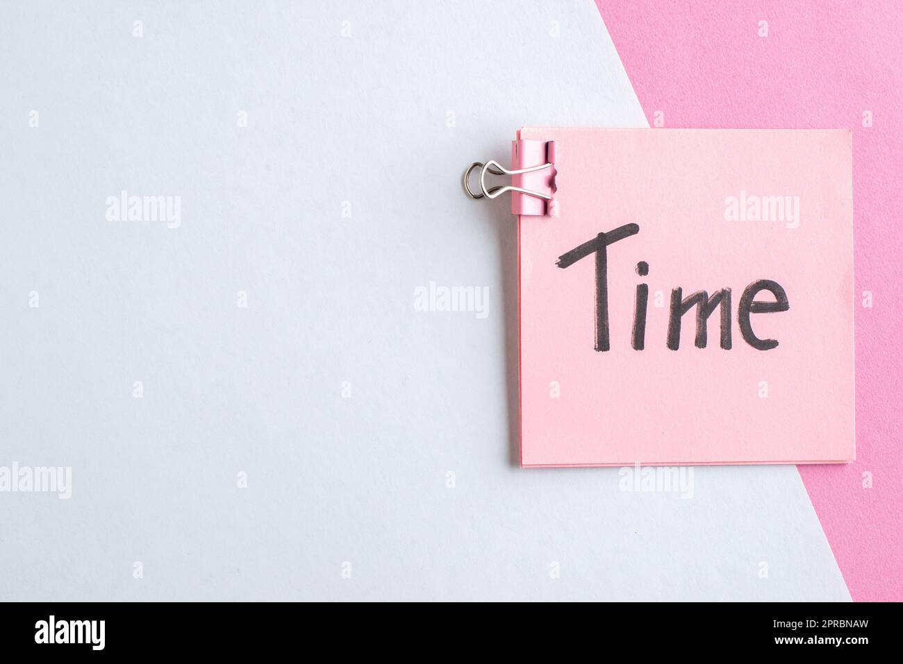 top view time written note on pink sticker white-pink background job ...