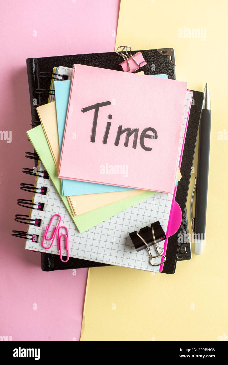 top view time written note with stickers on yellow-pink background ...