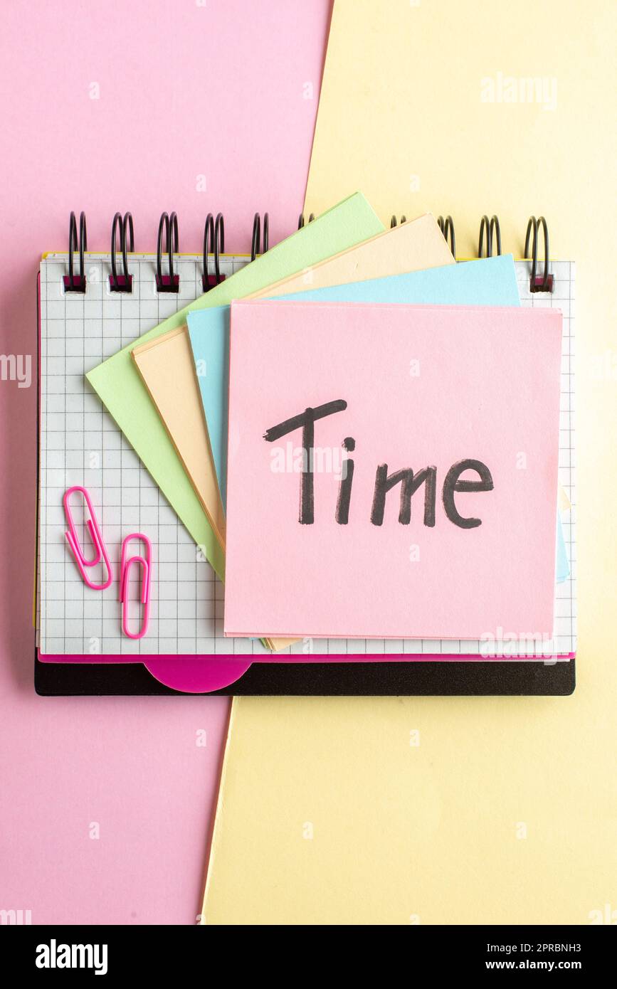 top view time written note with stickers on yellow-pink background ...