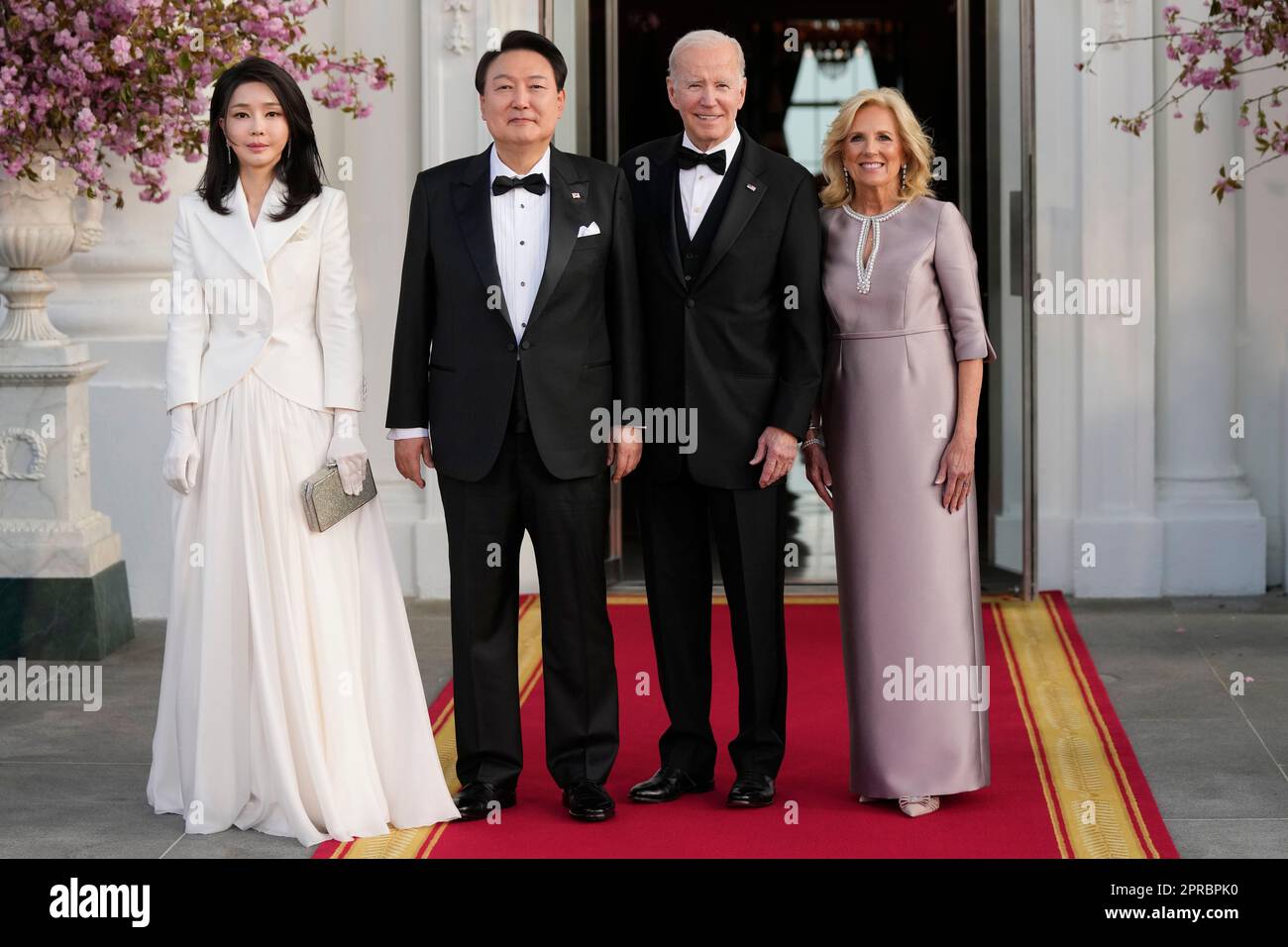President Joe Biden and first lady Jill Biden pose for photos with ...
