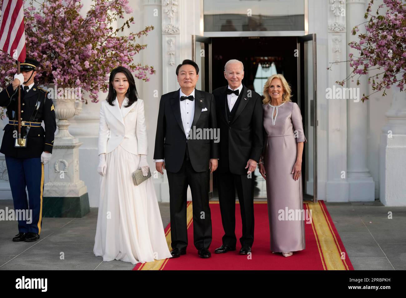 President Joe Biden and first lady Jill Biden pose for photos with ...