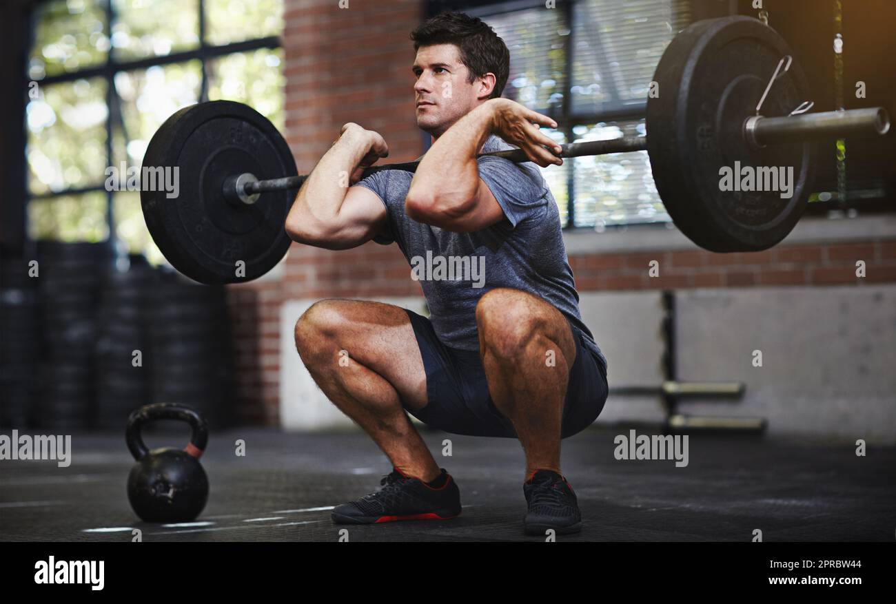 Ready for the lift. a young man lifting weights in a gym Stock Photo ...