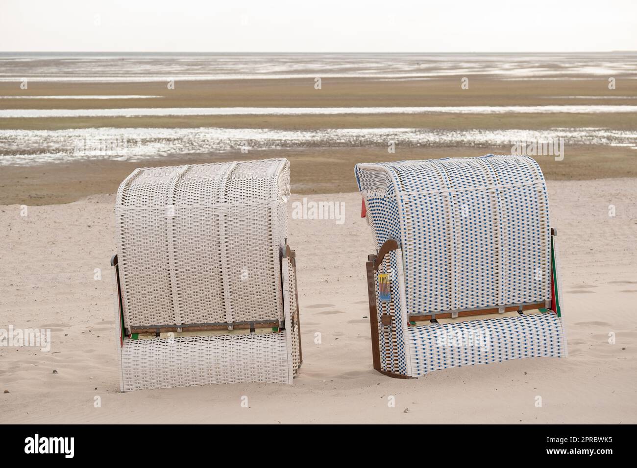 Beach box on the Wadden Sea.Beach wicker boxes set on white sand.Fer ...