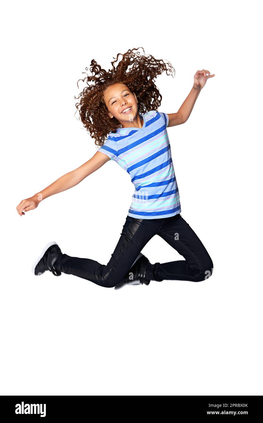 Full of youthful exhuberance. Studio shot of a young girl jumping for ...