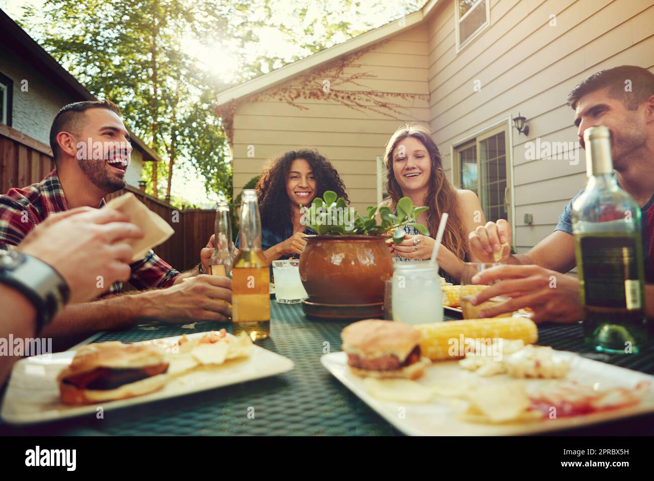 Outdoor summer dining. a group of friends having lunch in their ...