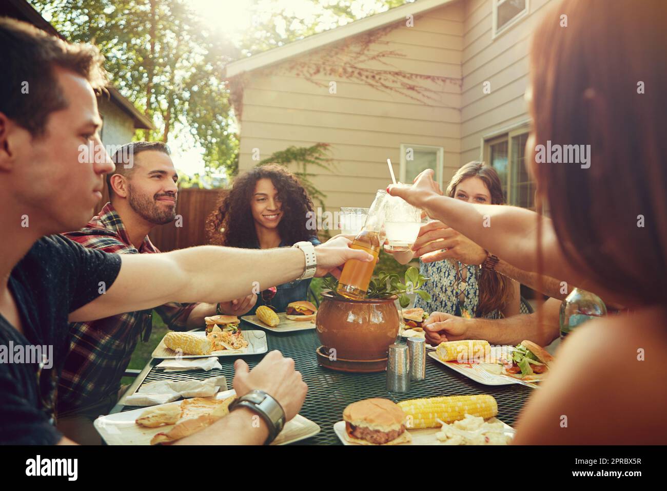 Getting together to celebrate summer. a group of friends having lunch ...