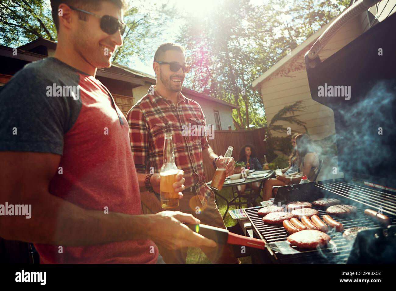 People standing around barbecue grill hi-res stock photography and ...