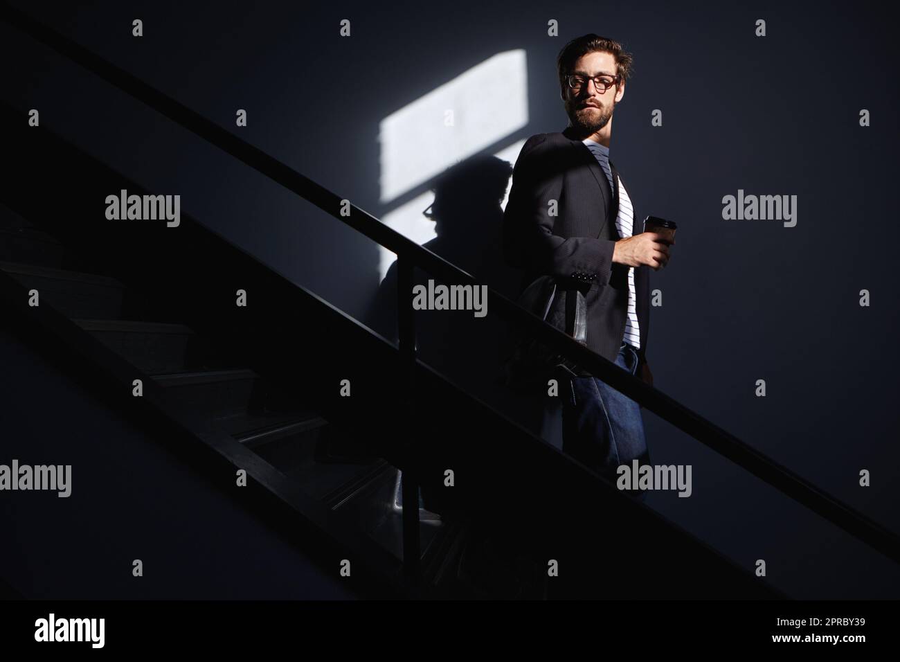 On the move in style. a stylish and confident young man walking down a ...