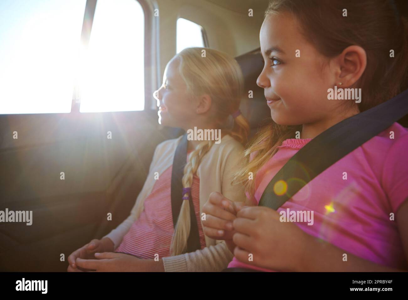 Road trip memories in the making. a two little girls traveling in a car ...