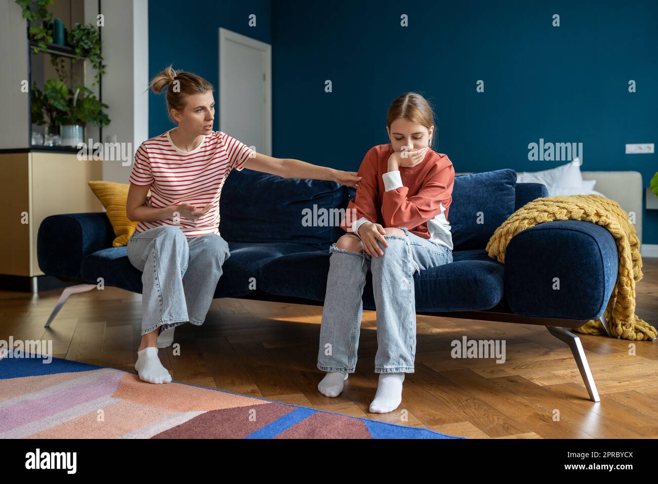 Young woman loving mother trying to speak with upset depressed teen daughter Stock Photo - Alamy