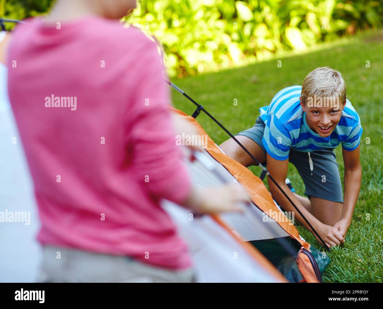 Right, first step pitching the tent. two young boys putting up their ...