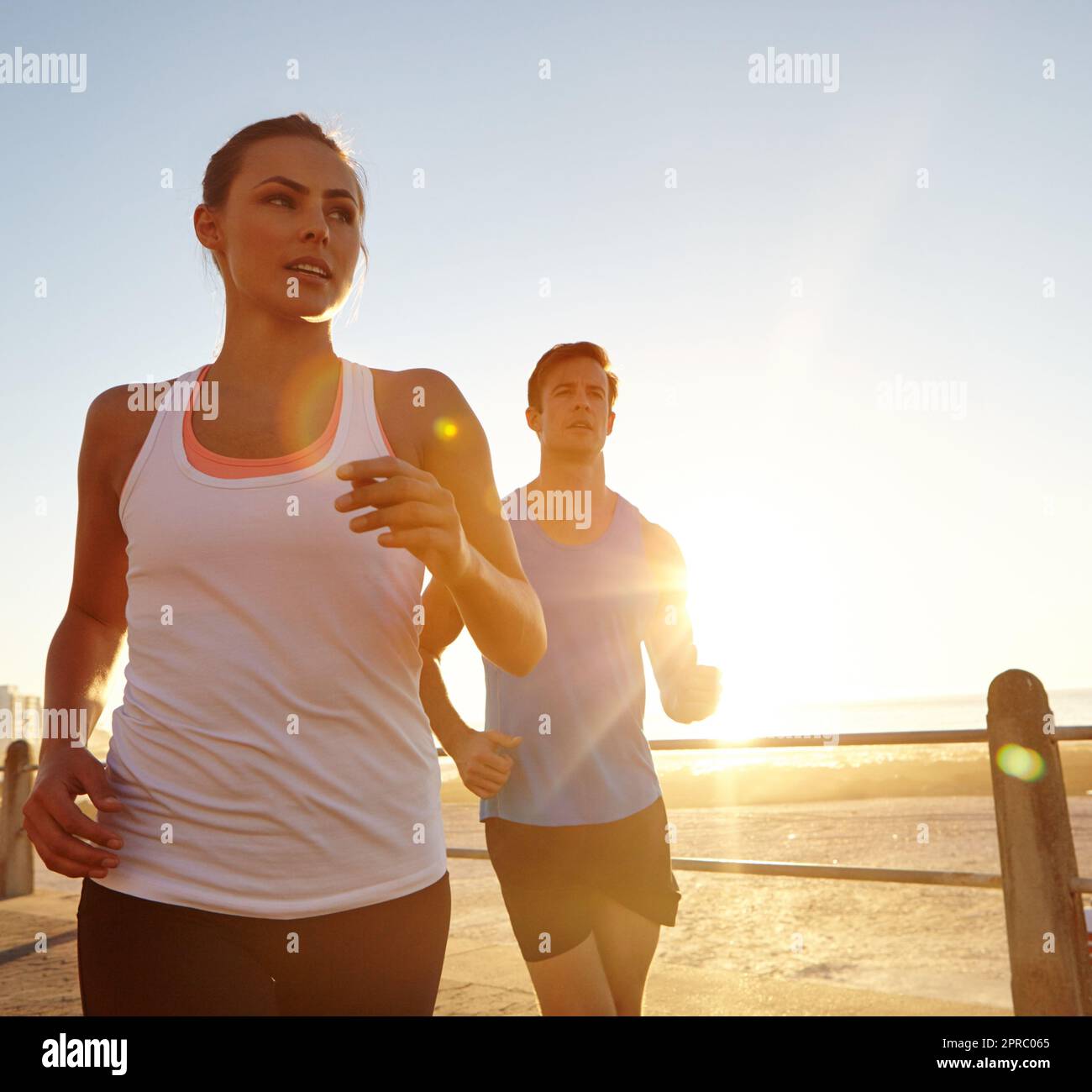 Making time to workout is a choice. a young couple jogging together on ...