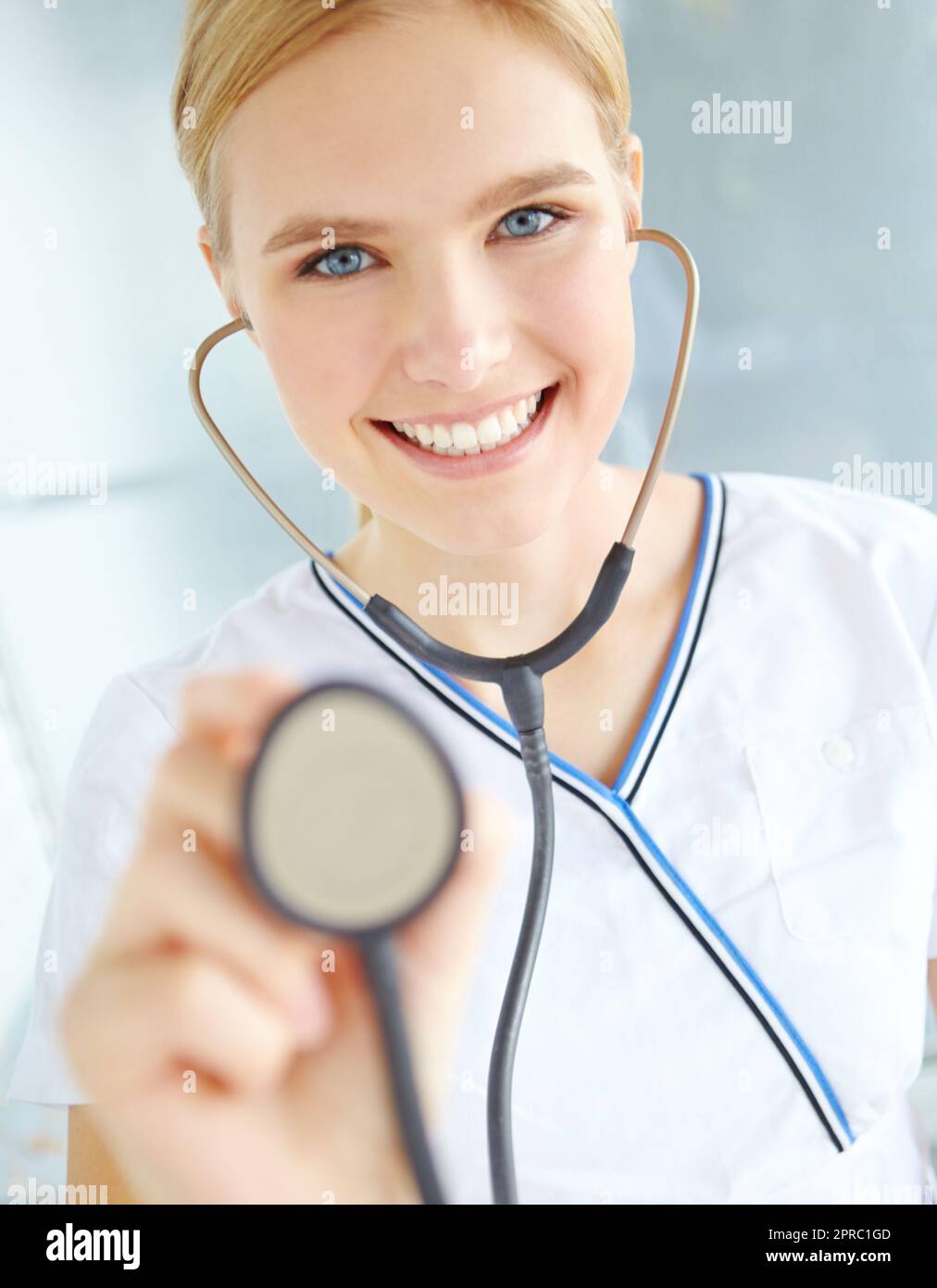 Lets check the ticker...Portrait of a pretty nurse holding up a ...