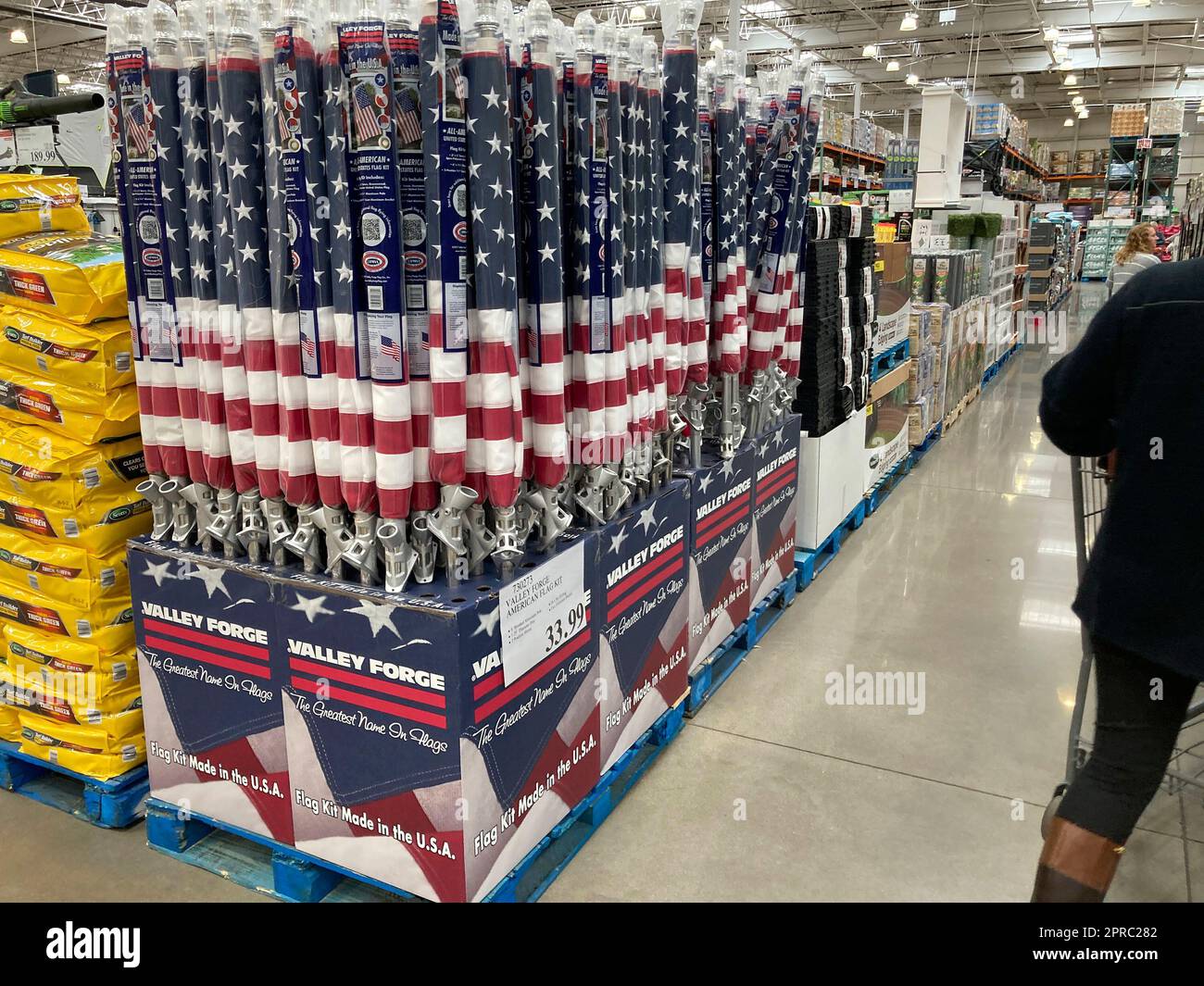 A shopper passes by a display of American flags in a Costco warehouse ...